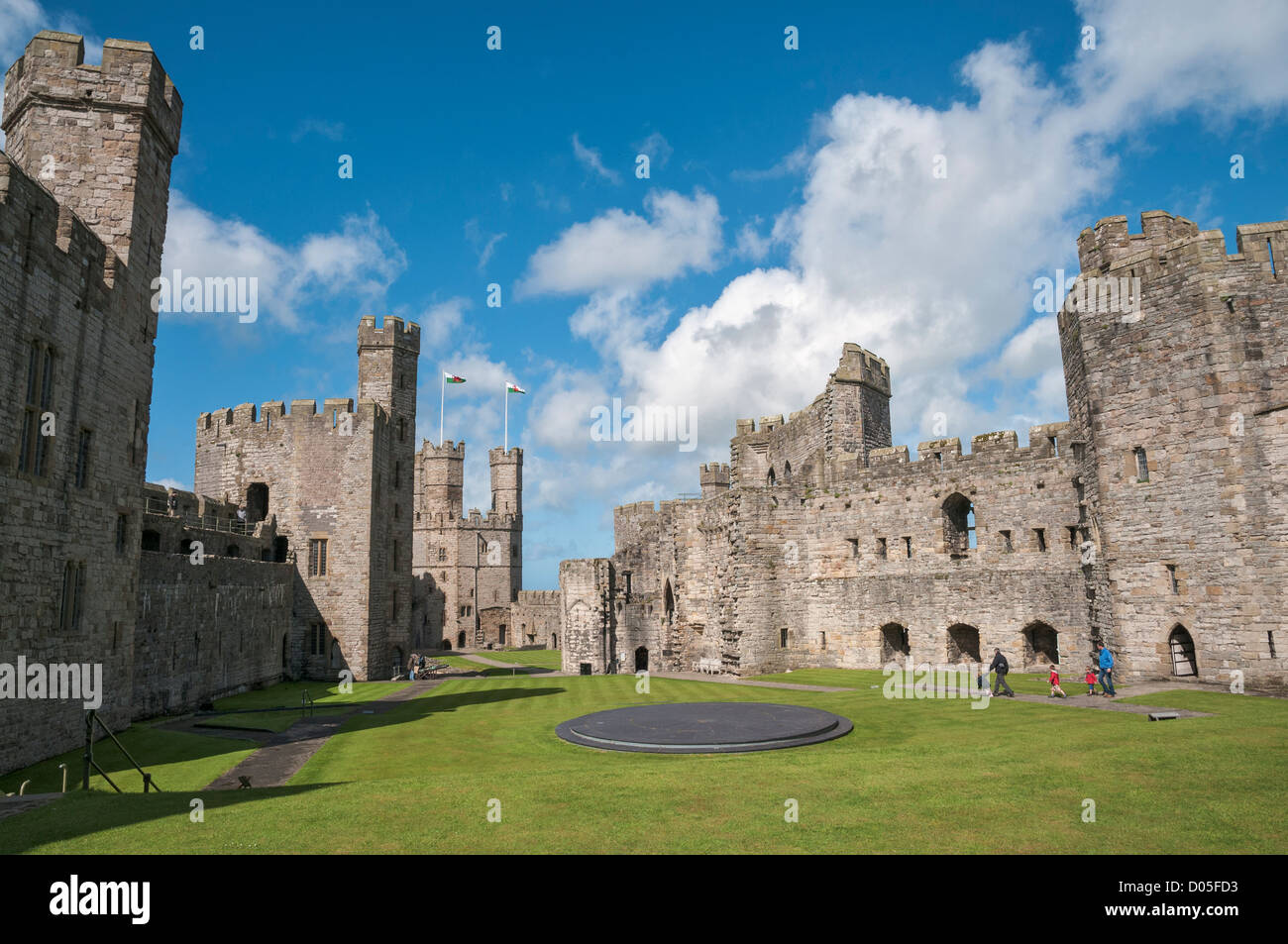 Wales, County Gwynedd, Caernarfon Castle, Welsh flags atop Eagle Tower ...