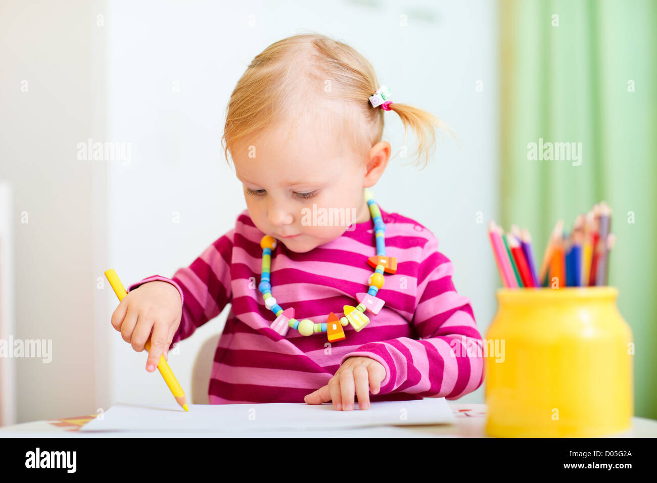 Toddler girl coloring with pencils Stock Photo - Alamy