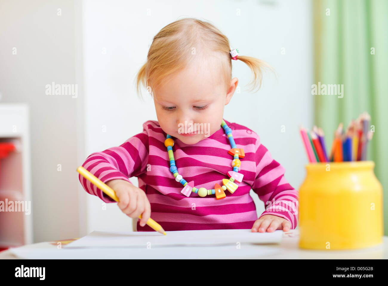 Toddler girl drawing with pencils Stock Photo - Alamy