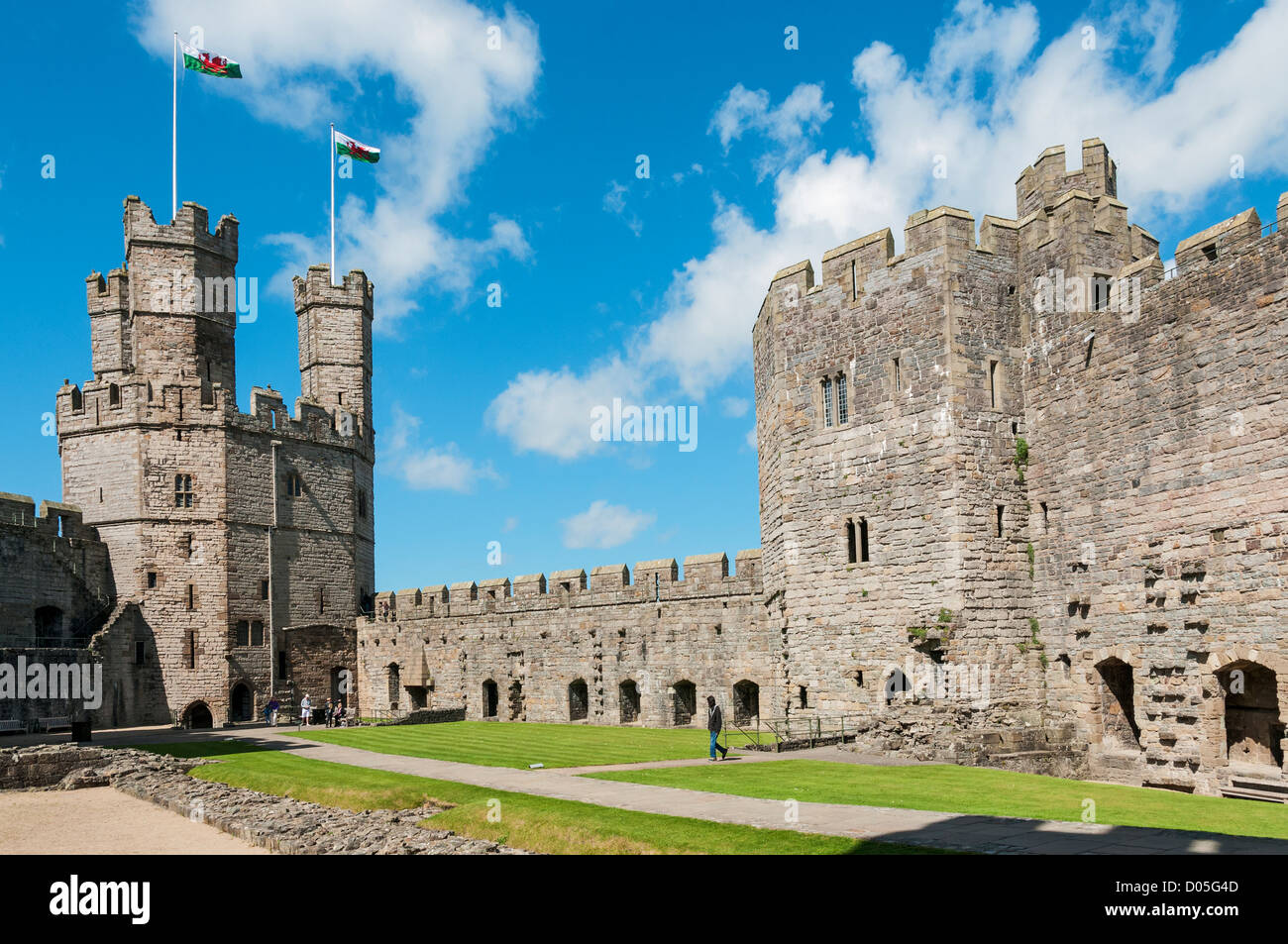 Wales, County Gwynedd, Caernarfon Castle, Welsh flags atop Eagle Tower ...
