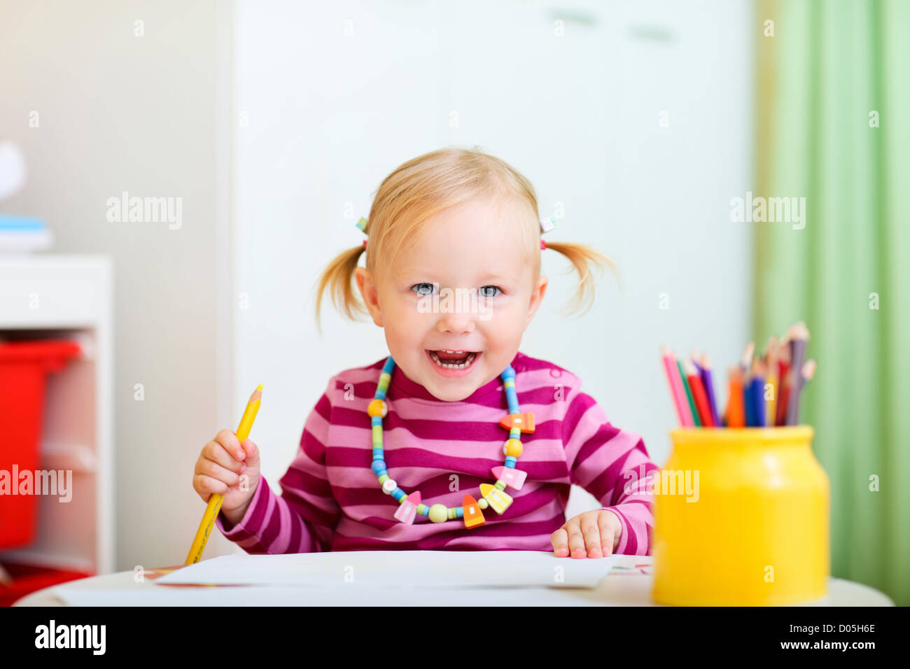 Toddler girl drawing with pencils Stock Photo - Alamy