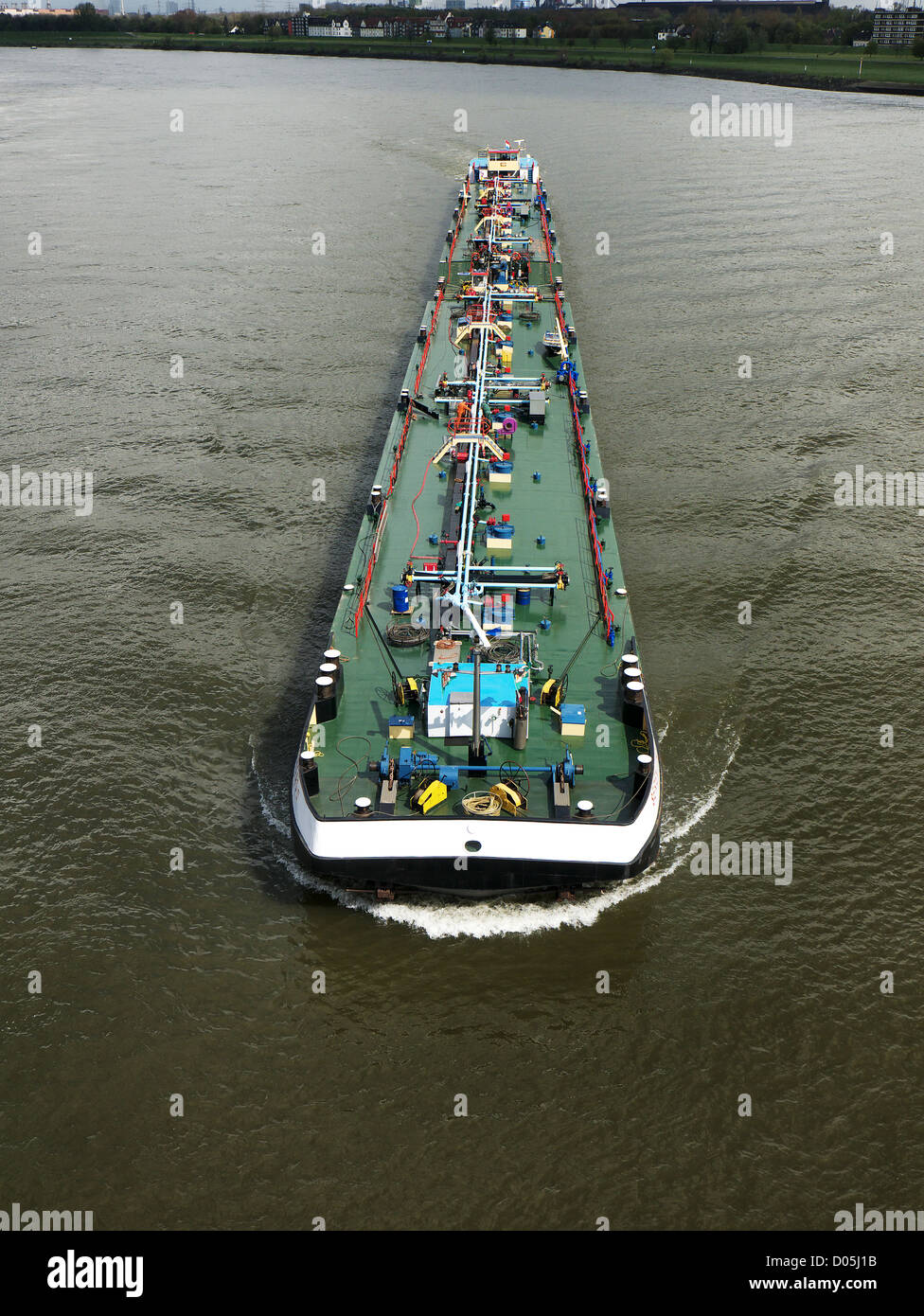 Tanker barge sailing on the Rhine upstream passing Duisburg, Germany ...