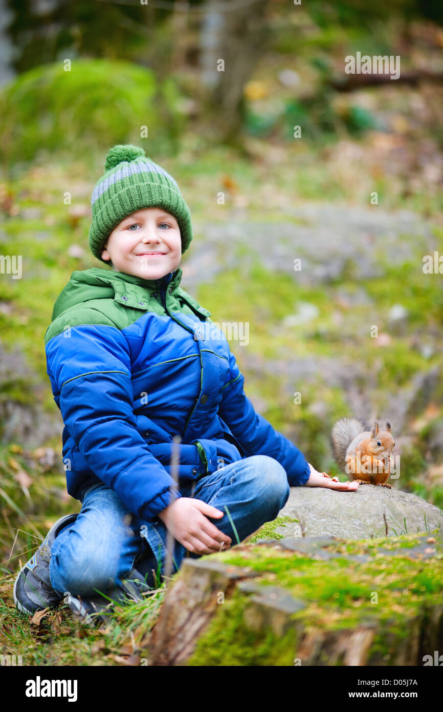 Cute boy and squirrel Stock Photo - Alamy