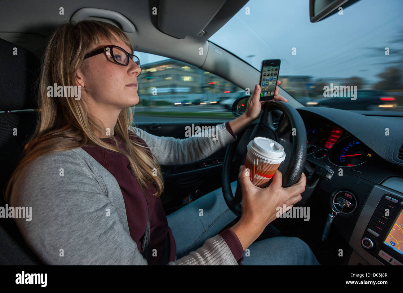 Woman is driving a car. Using a mobile phone. Not allowed while driving ...
