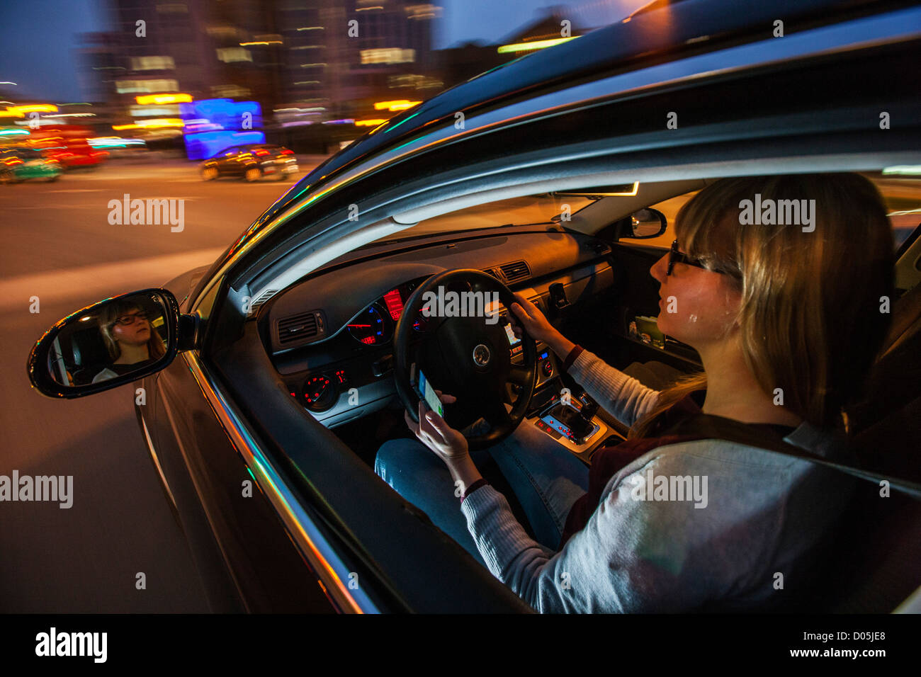 Woman is driving a car. Using a mobile phone. Not allowed while driving ...