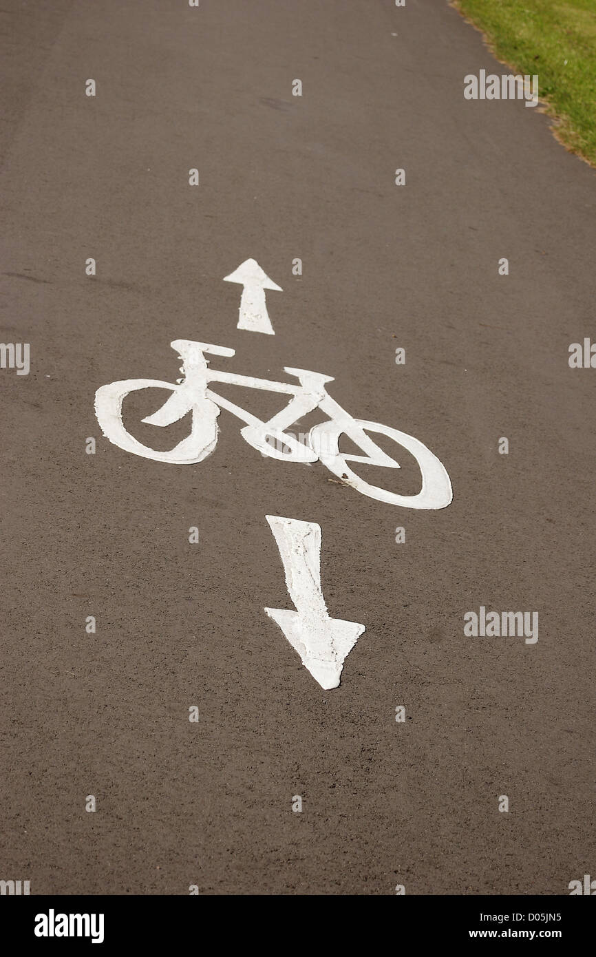 Direction sign painted in the road for cyclists to move on to a ...