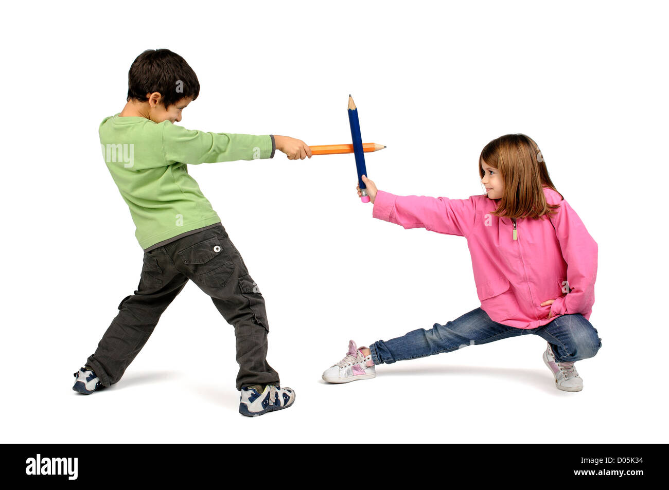 Children couple playing with large pencils isolated in white Stock ...