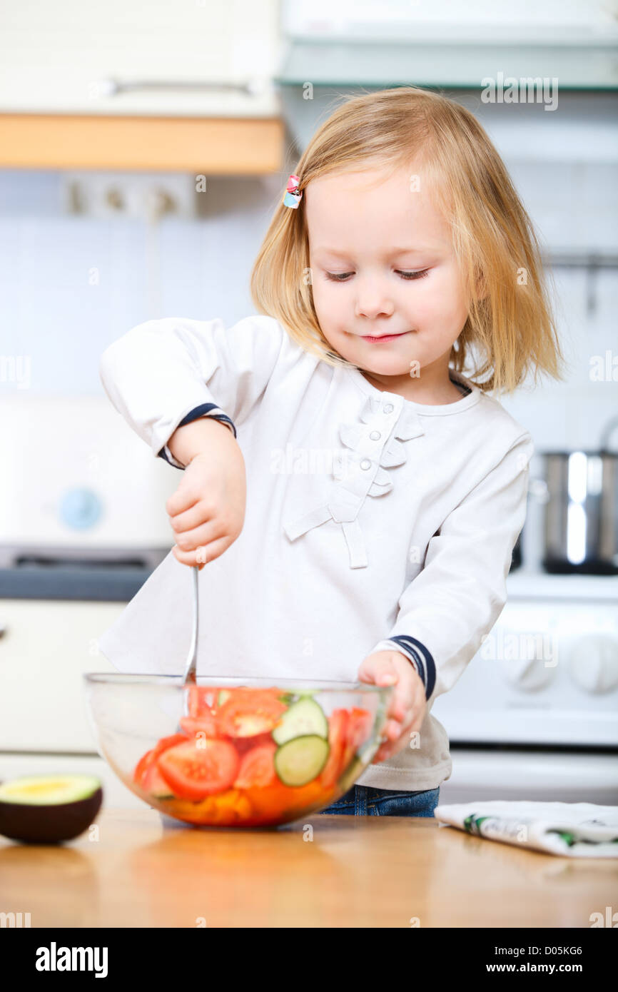 Adorable little girl helping at kitchen Stock Photo - Alamy