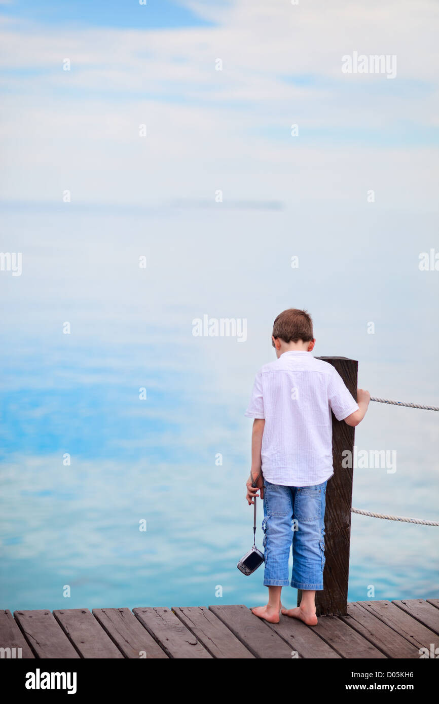 Little boy looking at ocean Stock Photo - Alamy