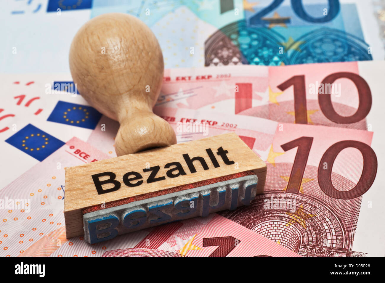 Detail photo of various Euro bills, a stamp with the German inscription ...