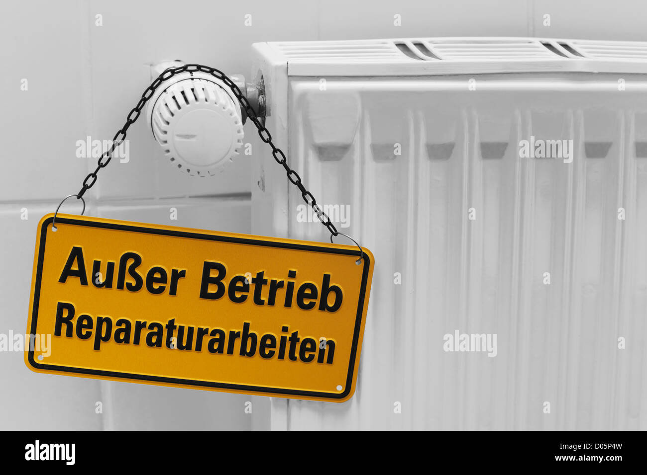 Detail photo of a radiator. A sign "not working, repair work" in German ...