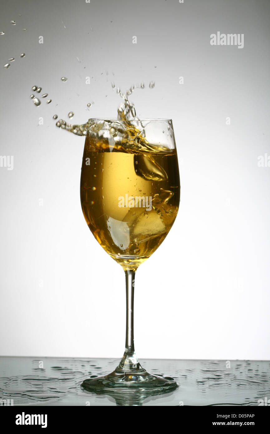 alcohol splash on gray background Stock Photo - Alamy