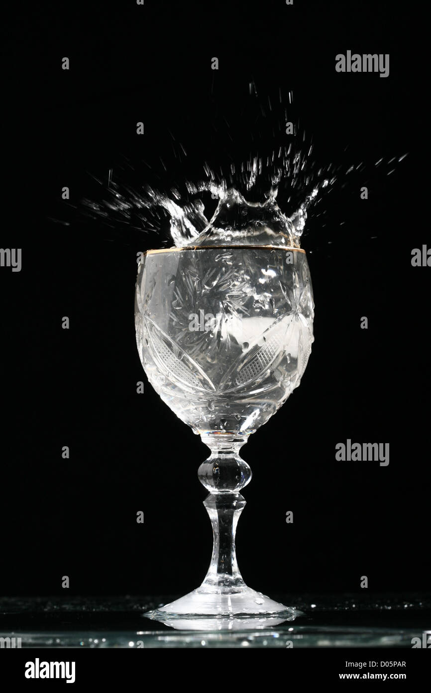 alcohol splash on black background Stock Photo - Alamy