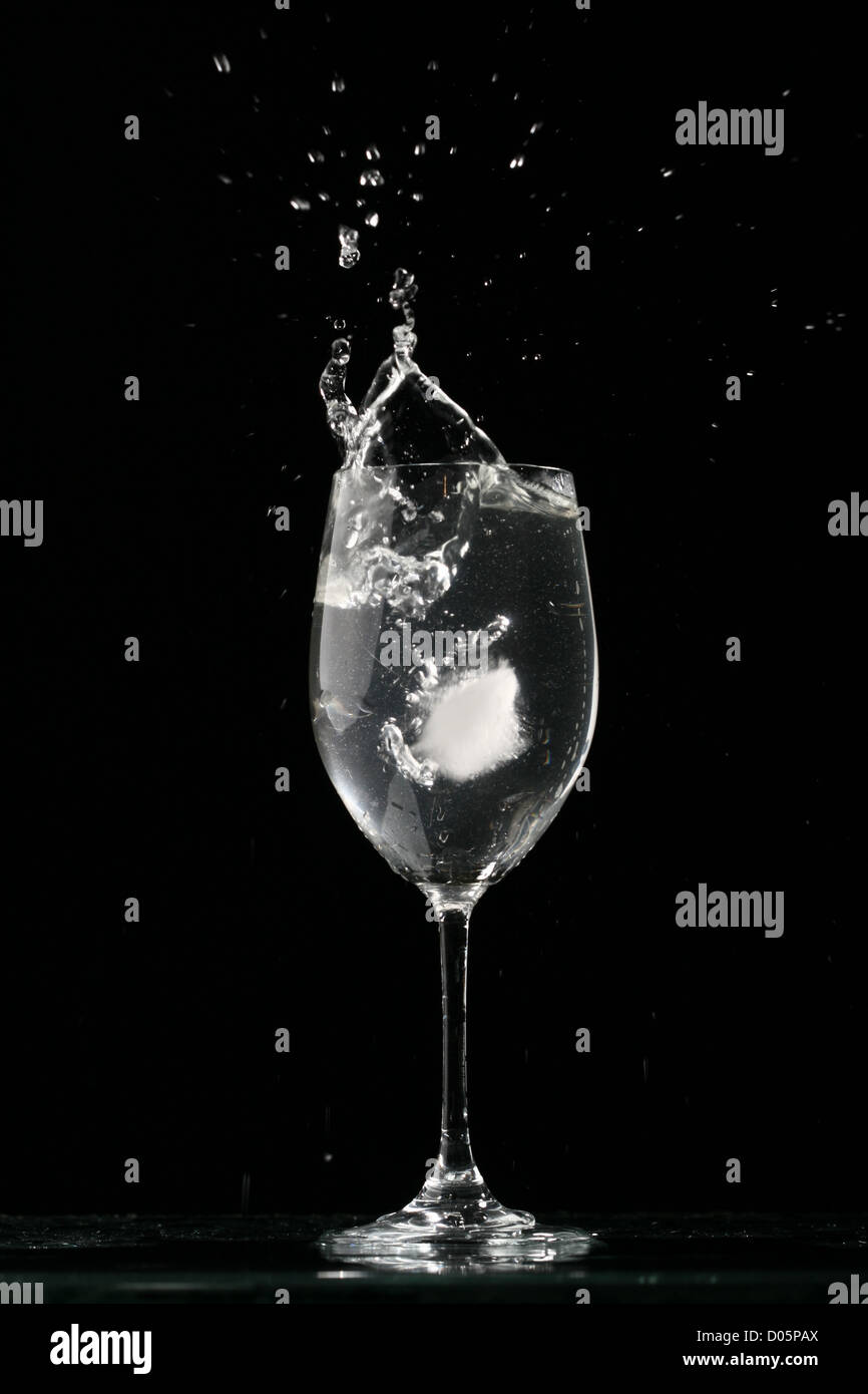alcohol splash on black background Stock Photo - Alamy