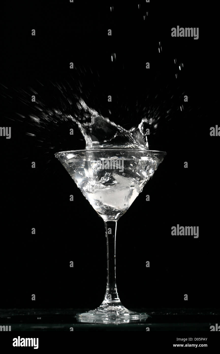 alcohol splash on black background Stock Photo - Alamy