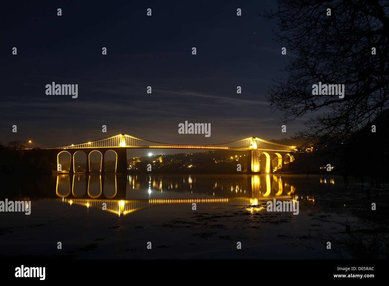 Menai Bridge lit up at night. The bridge is one of two joining Anglesey ...