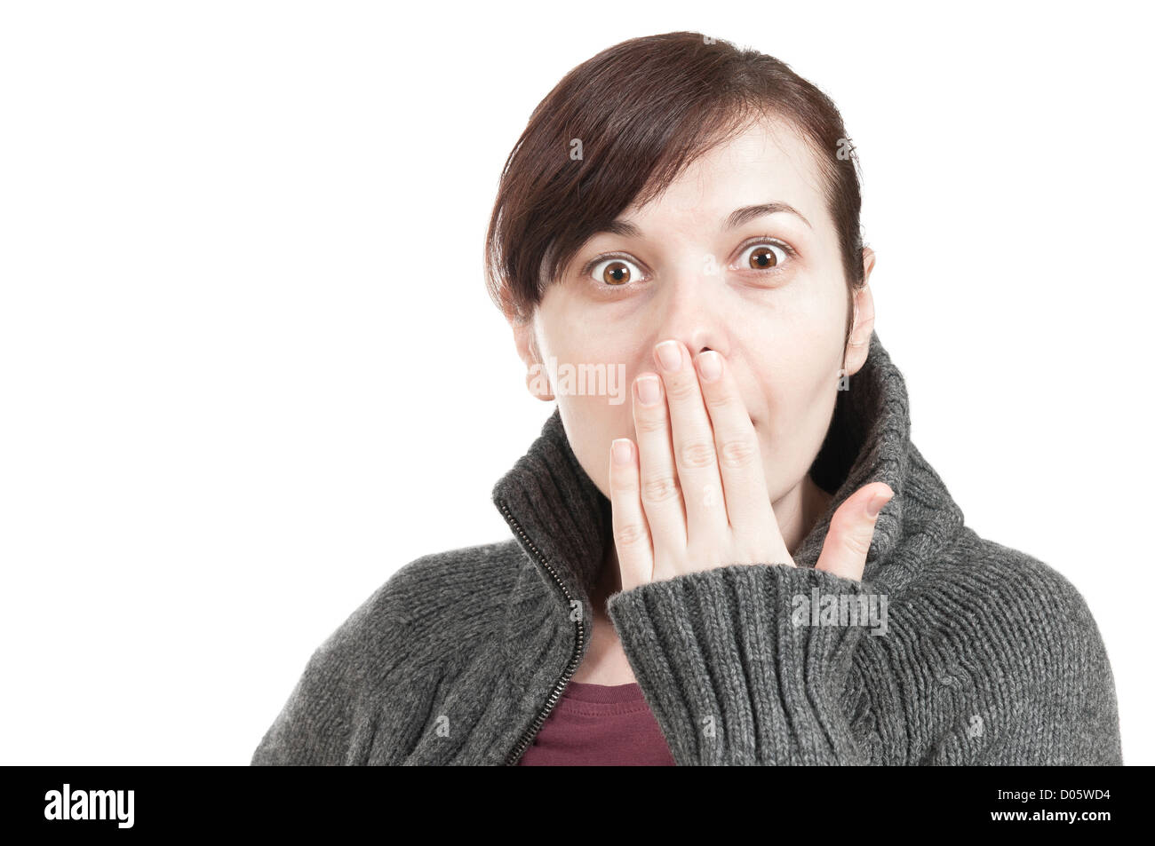 Surprised woman covering her mouth with hand over a white background ...