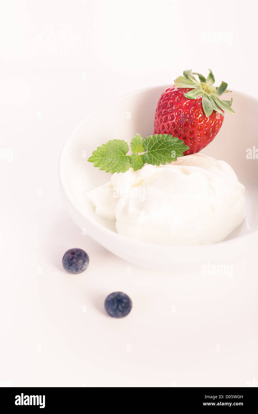 a cup with quark and strawberries Stock Photo - Alamy