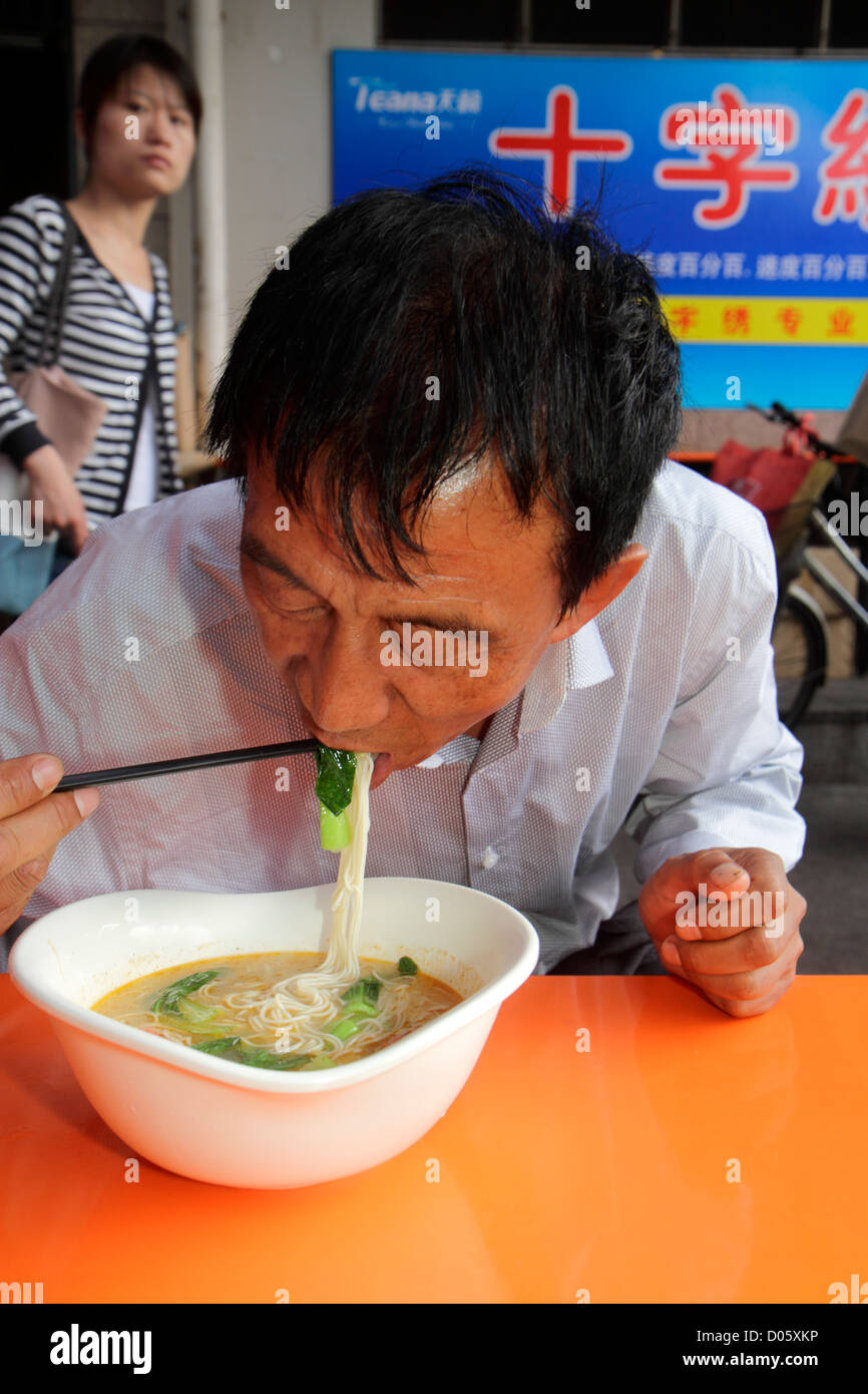 Restaurant food asian man using chopsticks noodles eating dining hi-res ...