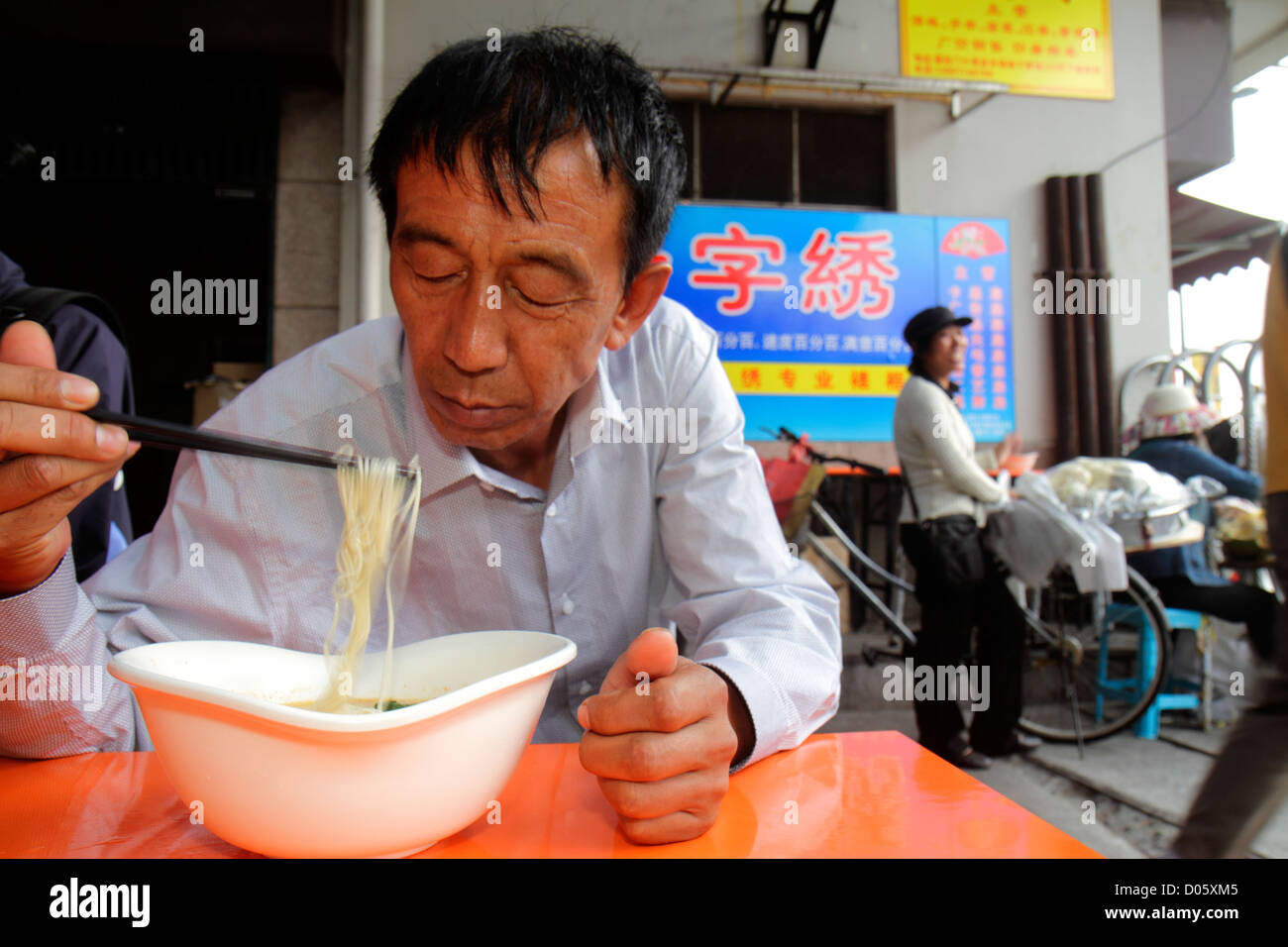 Restaurant food asian man using chopsticks noodles eating dining hi-res ...