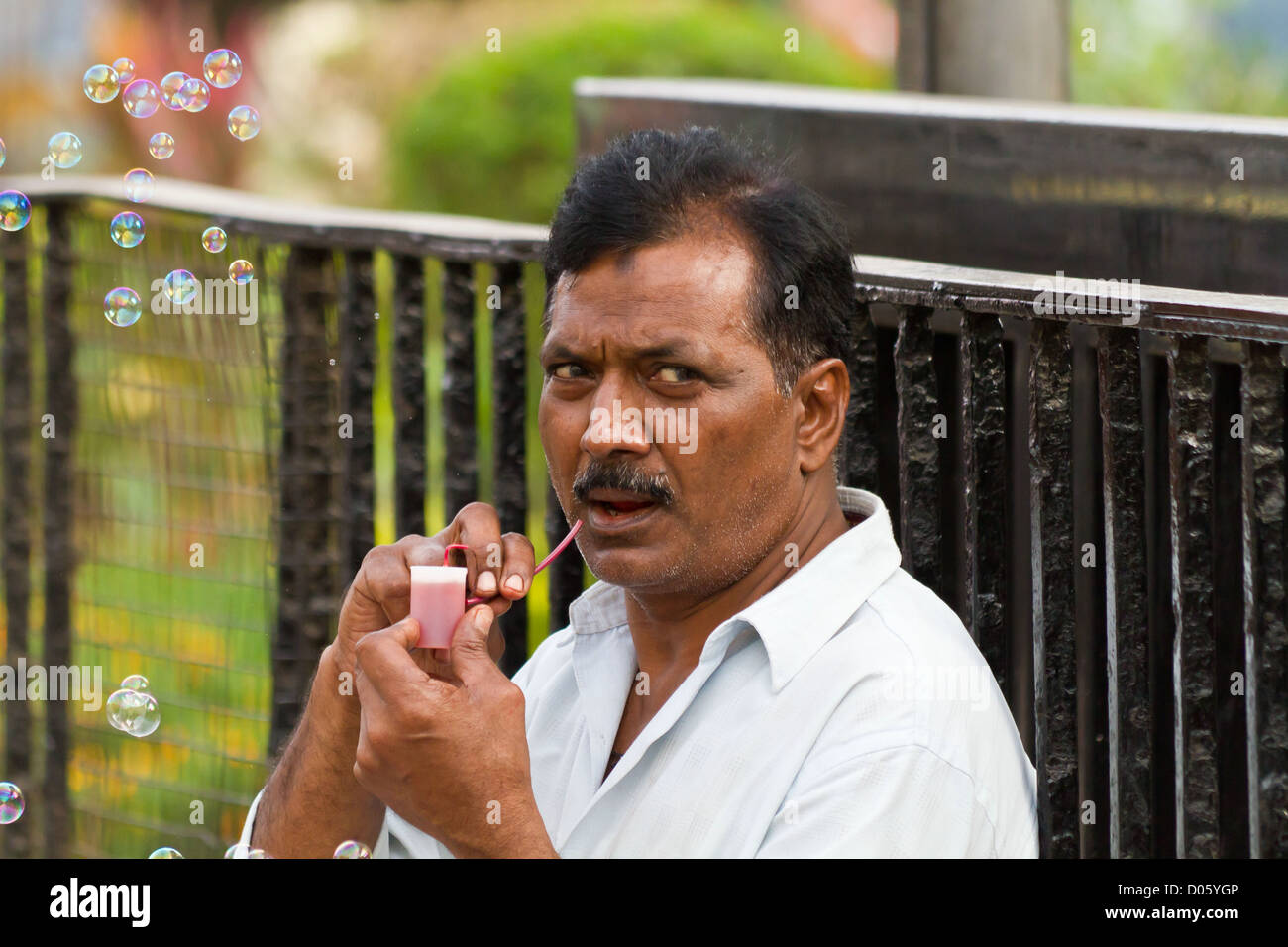 Indian man blowing bubbles hi-res stock photography and images - Alamy