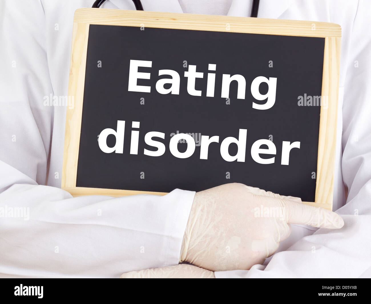 Doctor shows information on blackboard: eating disorder Stock Photo - Alamy