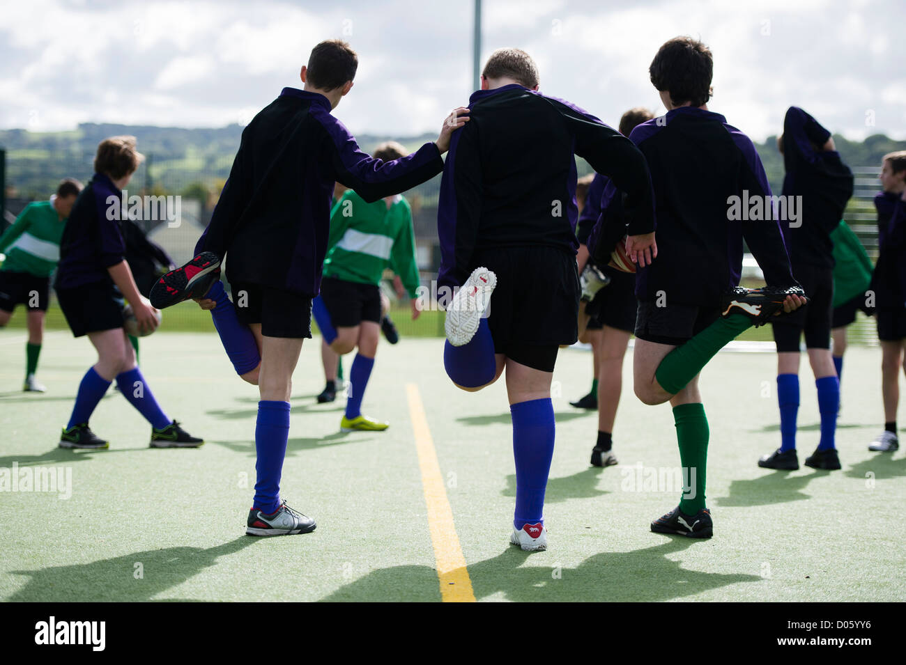 Teenage boys warming up before games lesson at a secondary ...