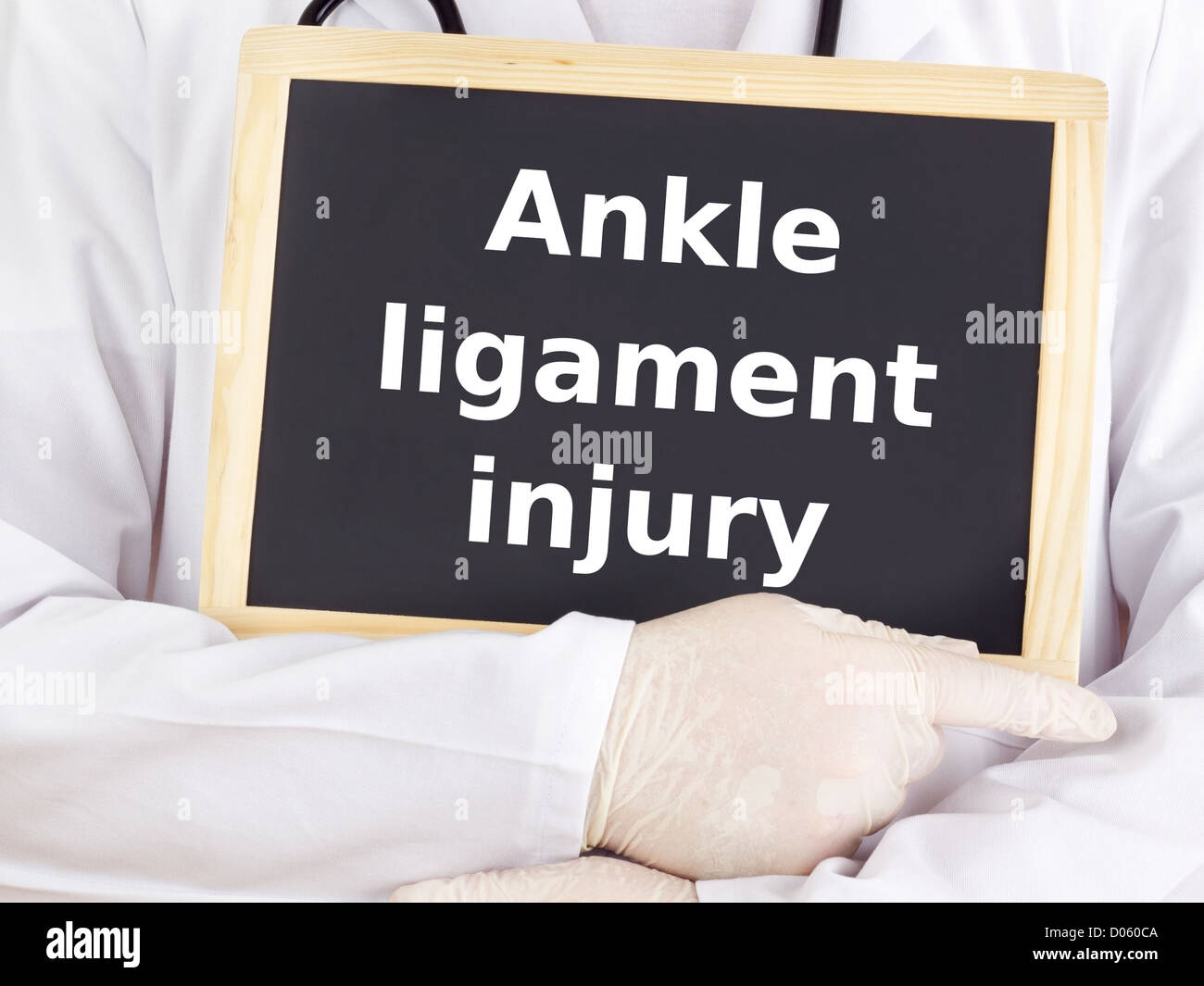 Doctor shows information: ankle ligament injury Stock Photo - Alamy