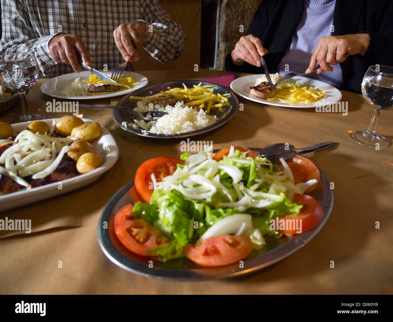 People eating at restaurant table Stock Photo - Alamy