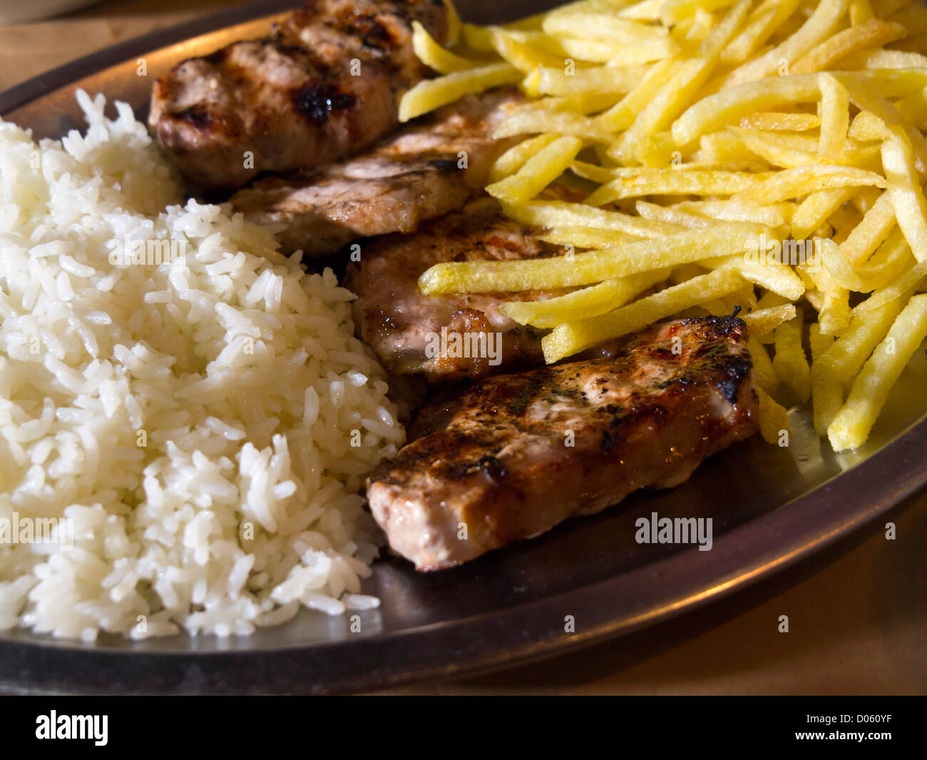Detail shot of grilled steaks with french fries and white rice Stock ...