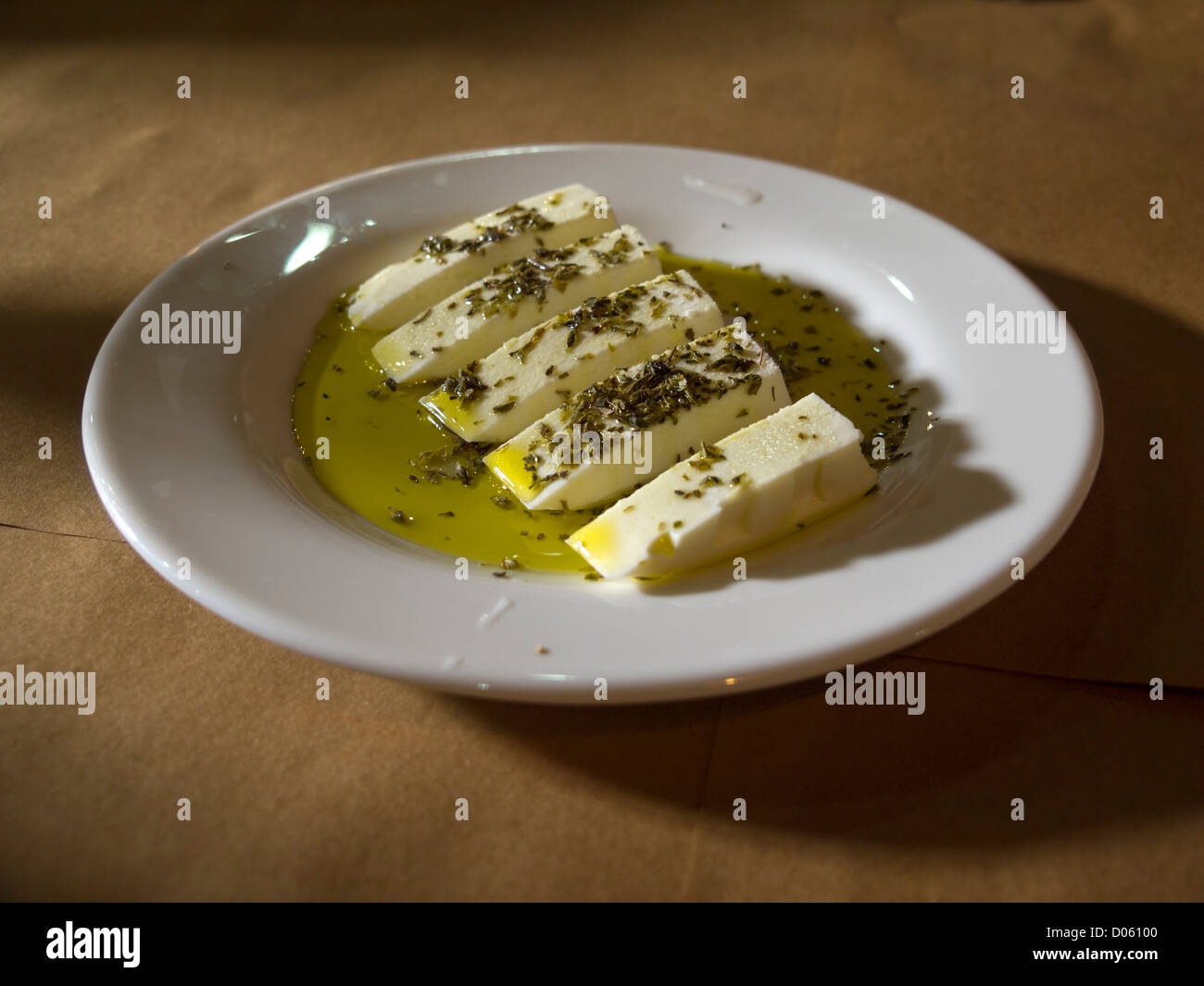 Plate of fresh white cheese (queijo fresco) with oregano and olive oil ...