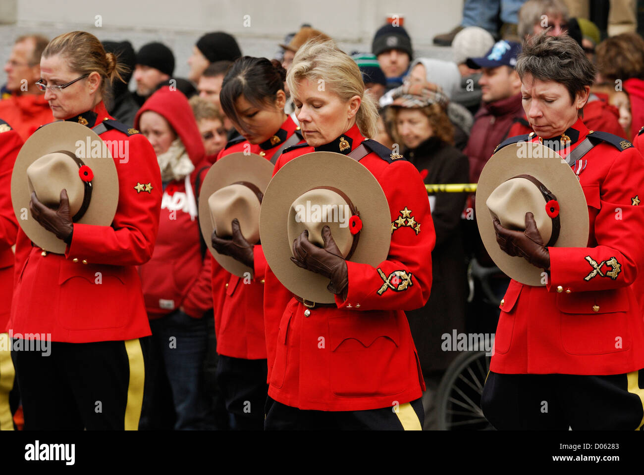 Female R.C.M.P. in full red serge hats lowered attending a remembrance ...