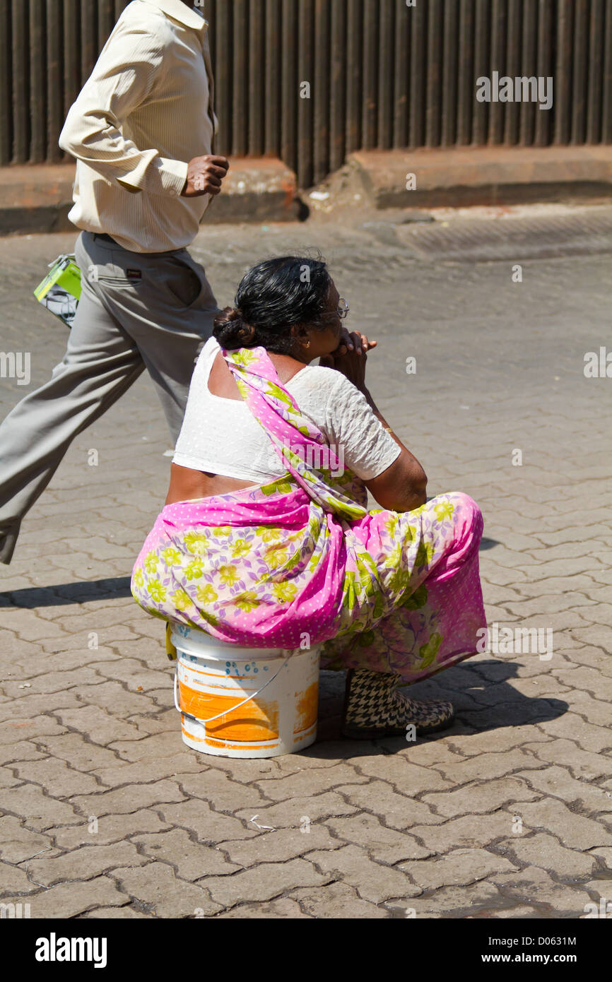 Woman sitting on a Plastic Bucket in Mumbai, India Stock Photo - Alamy