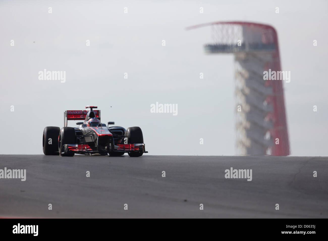 F1 driver Jenson Button races past the observation tower at the Circuit ...