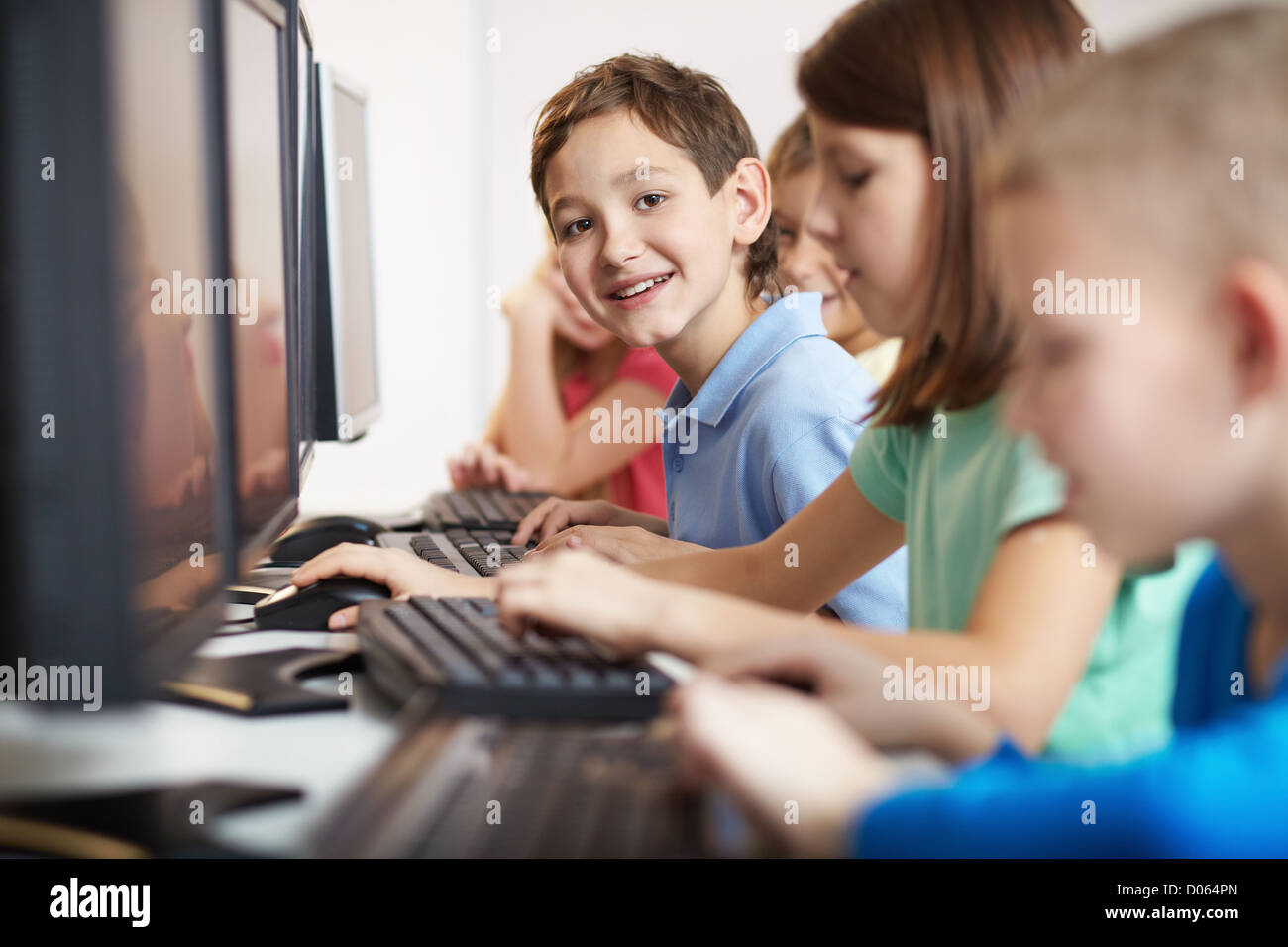 Portrait of smart lad looking at camera at computer lesson Stock Photo ...