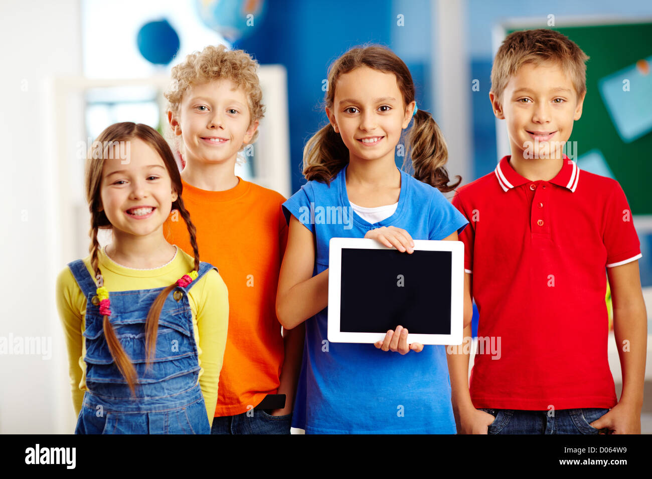 Portrait of smart schoolkids standing in line and looking at camera ...