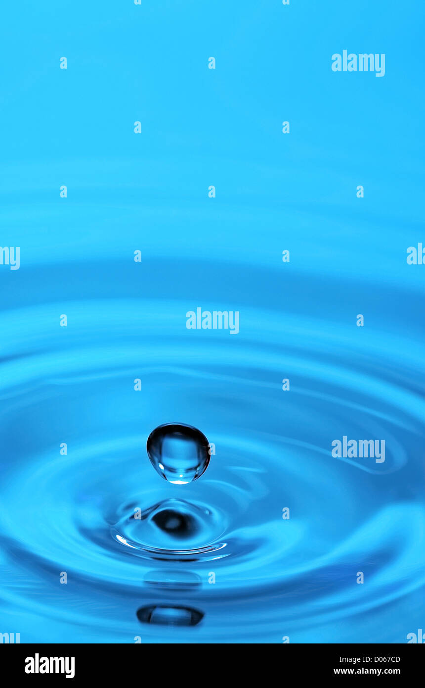 Close-up of a water drop that hits the water surface Stock Photo - Alamy