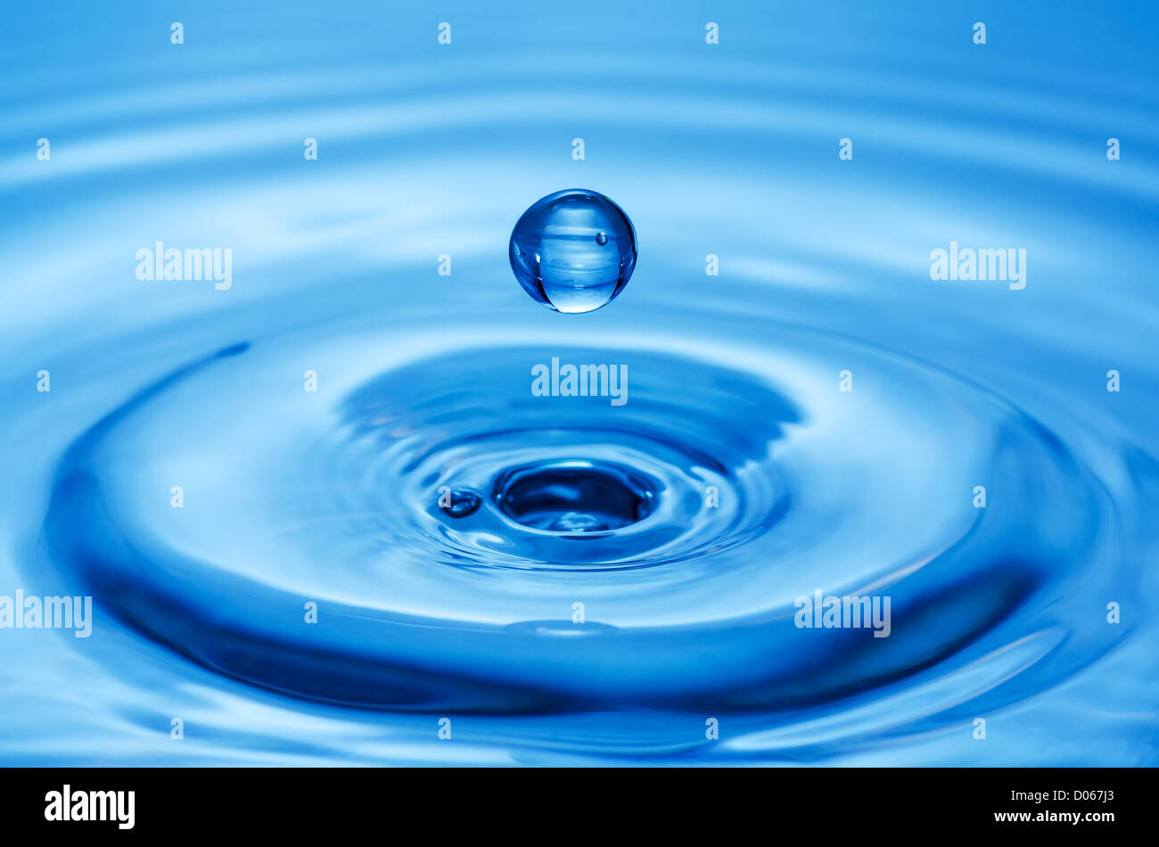 Close-up of a water drop that hits the water surface Stock Photo - Alamy
