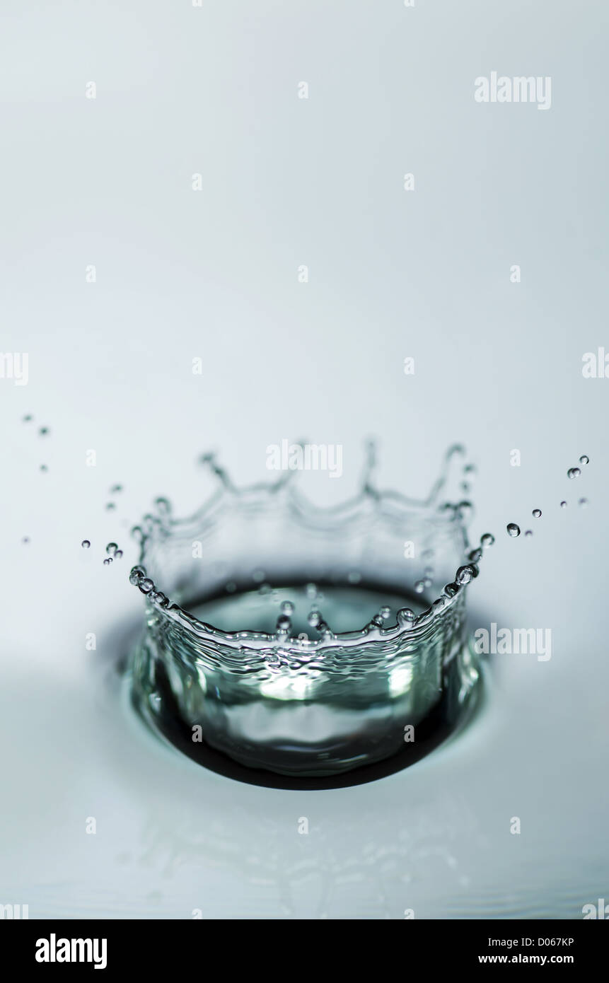 Close-up of a water drop that hits the water surface Stock Photo - Alamy