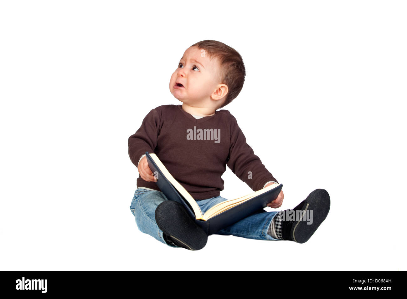 Beautiful baby with a book crying isolated on white background Stock ...