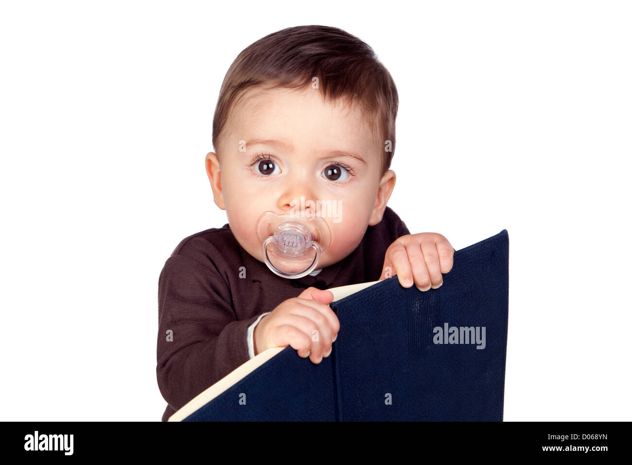 Beautiful baby with a pacifier reading isolated on white background ...