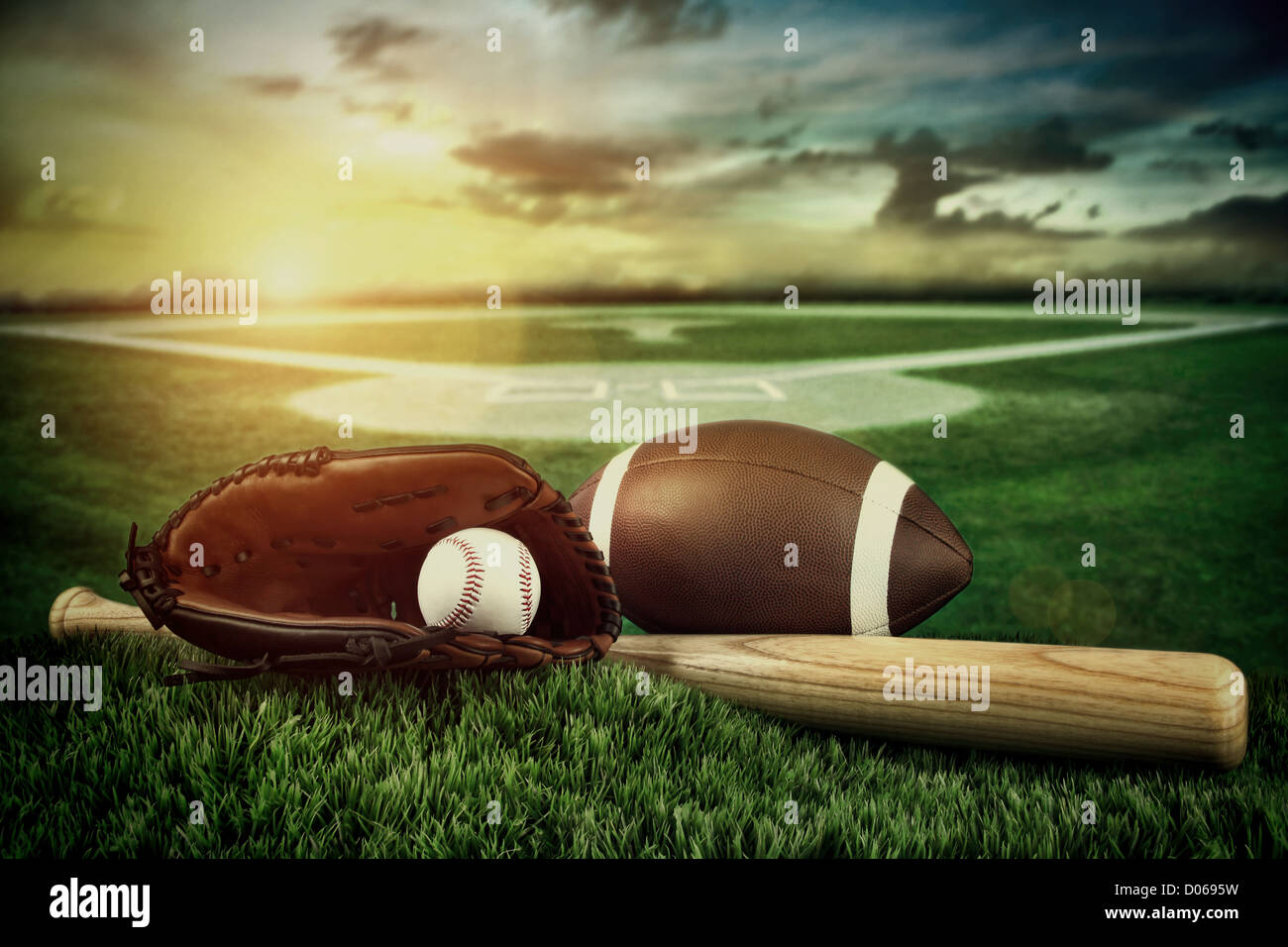 Baseball, bat, and mitt with field in background at sunset Stock Photo ...