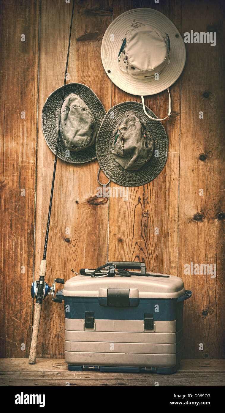 Hats hanging on wooden wall with fishing equipment Stock Photo - Alamy