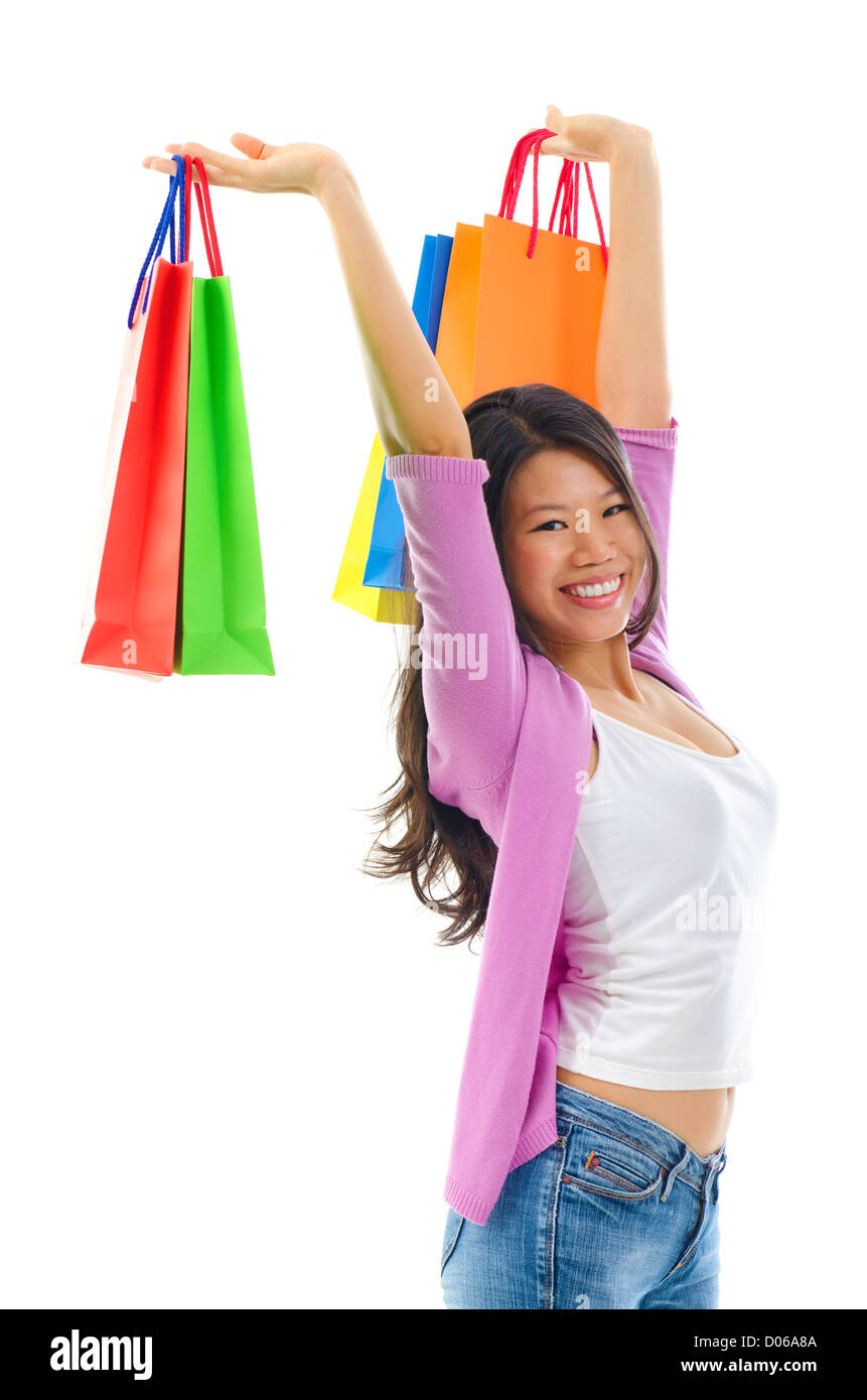 Happy shopper holding shopping bag high over white background Stock ...