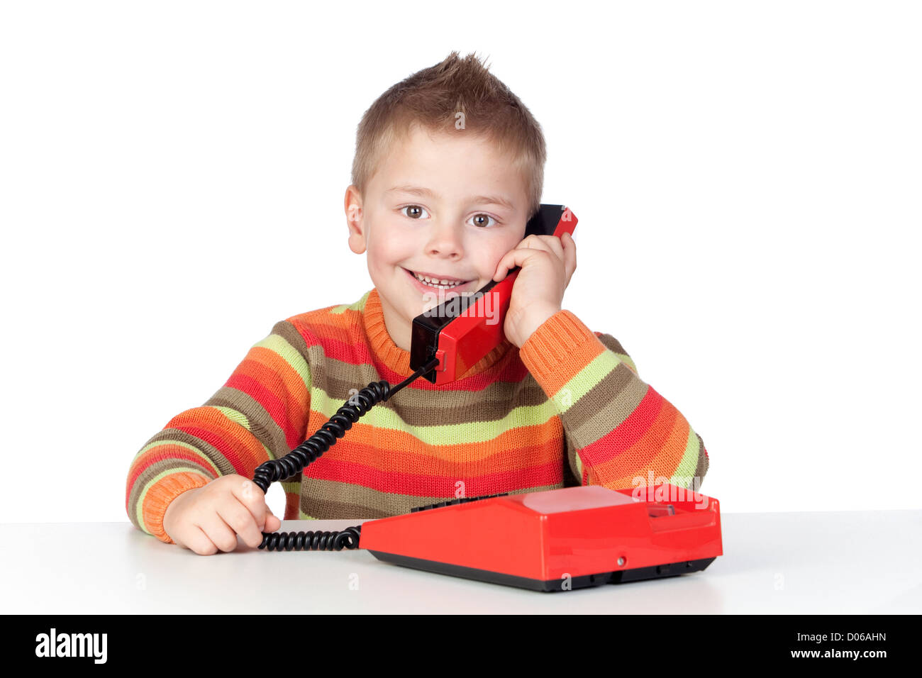 Adorable child with a tradicional telephone isolated over white Stock ...