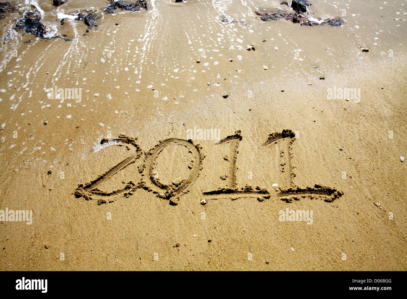 2011 written on sand Stock Photo - Alamy