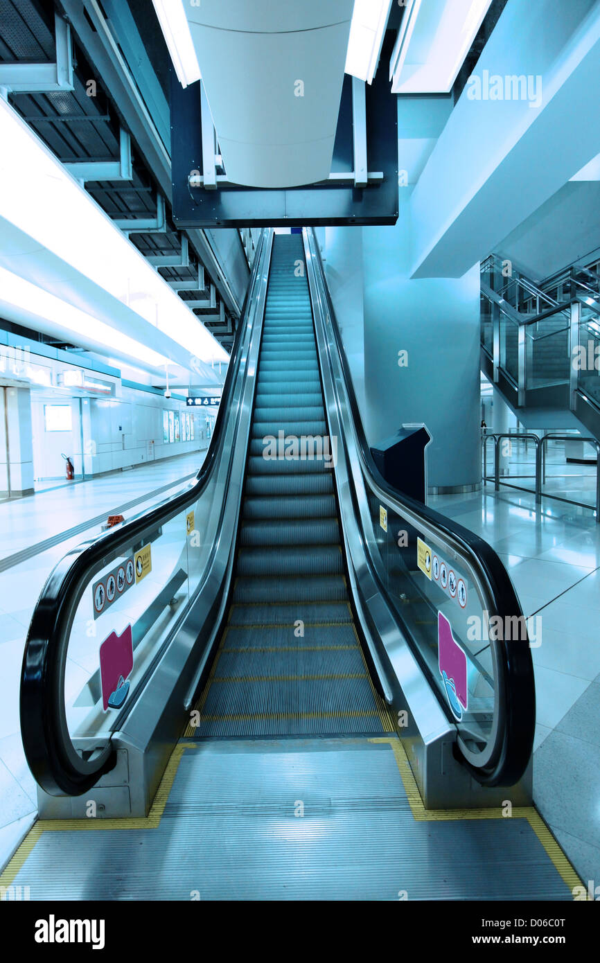 Moving escalator in subway station Stock Photo - Alamy
