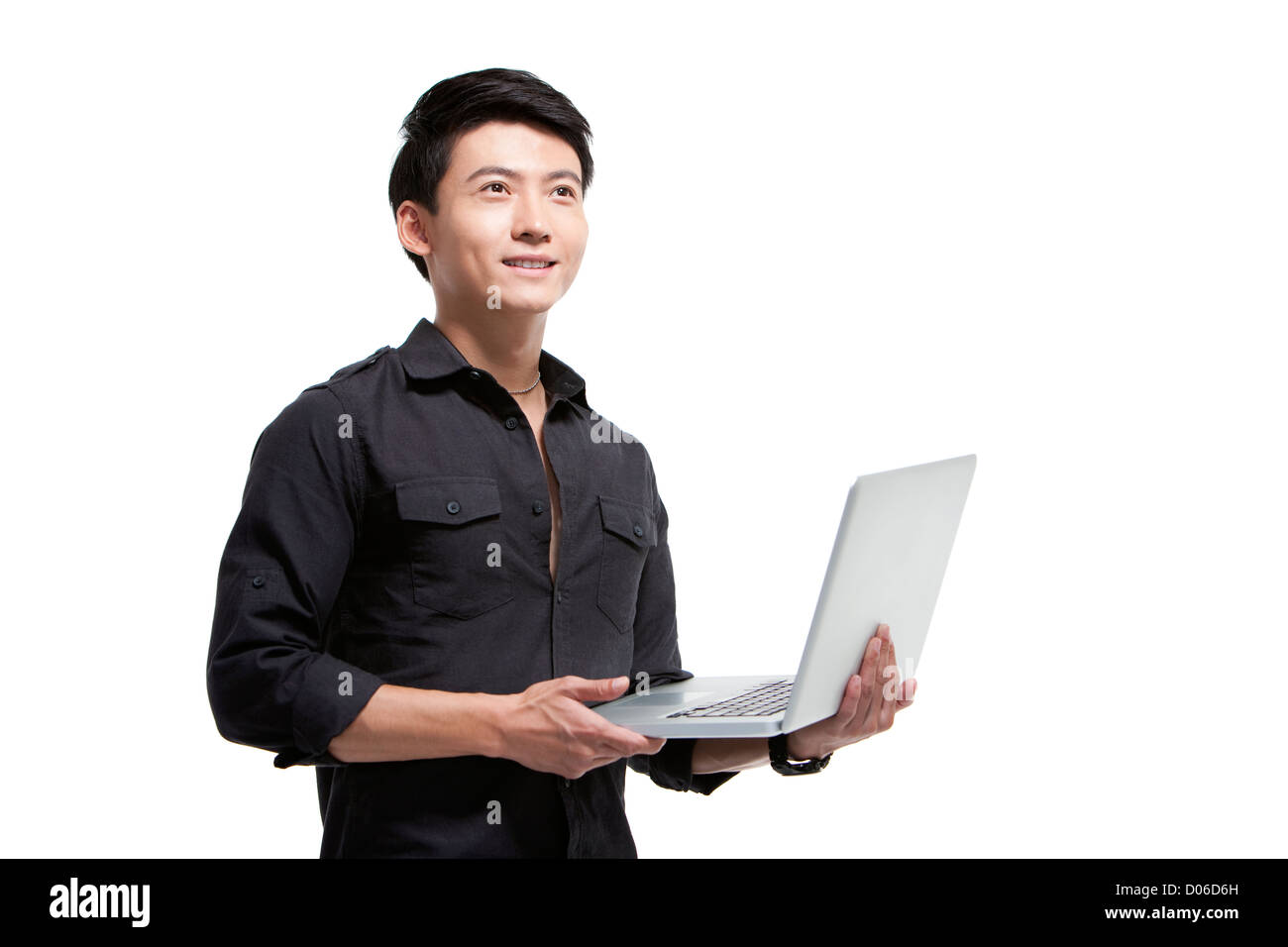 Man with laptop looking at view Stock Photo - Alamy