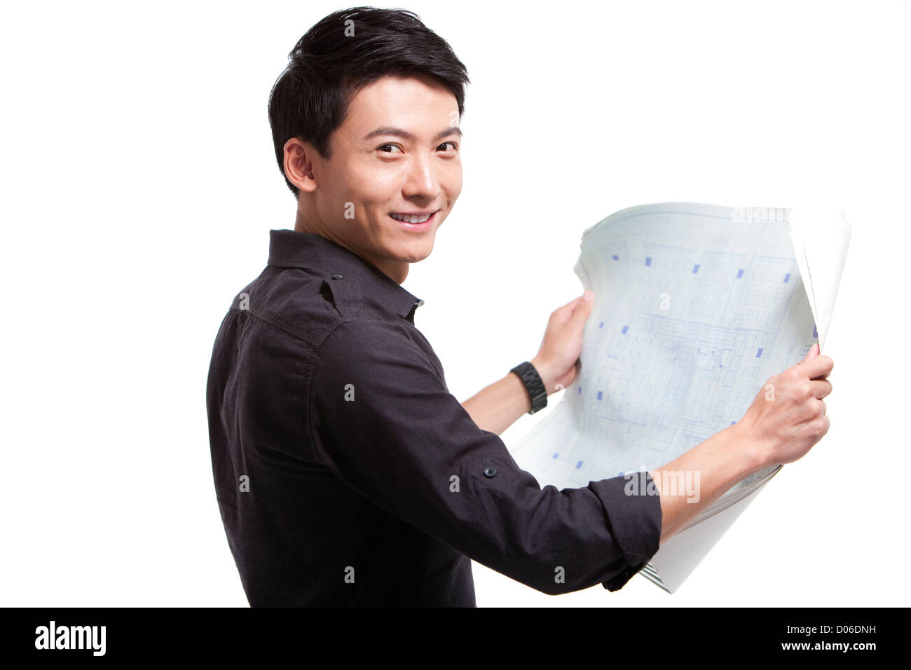 Young man with blueprint smiling Stock Photo - Alamy