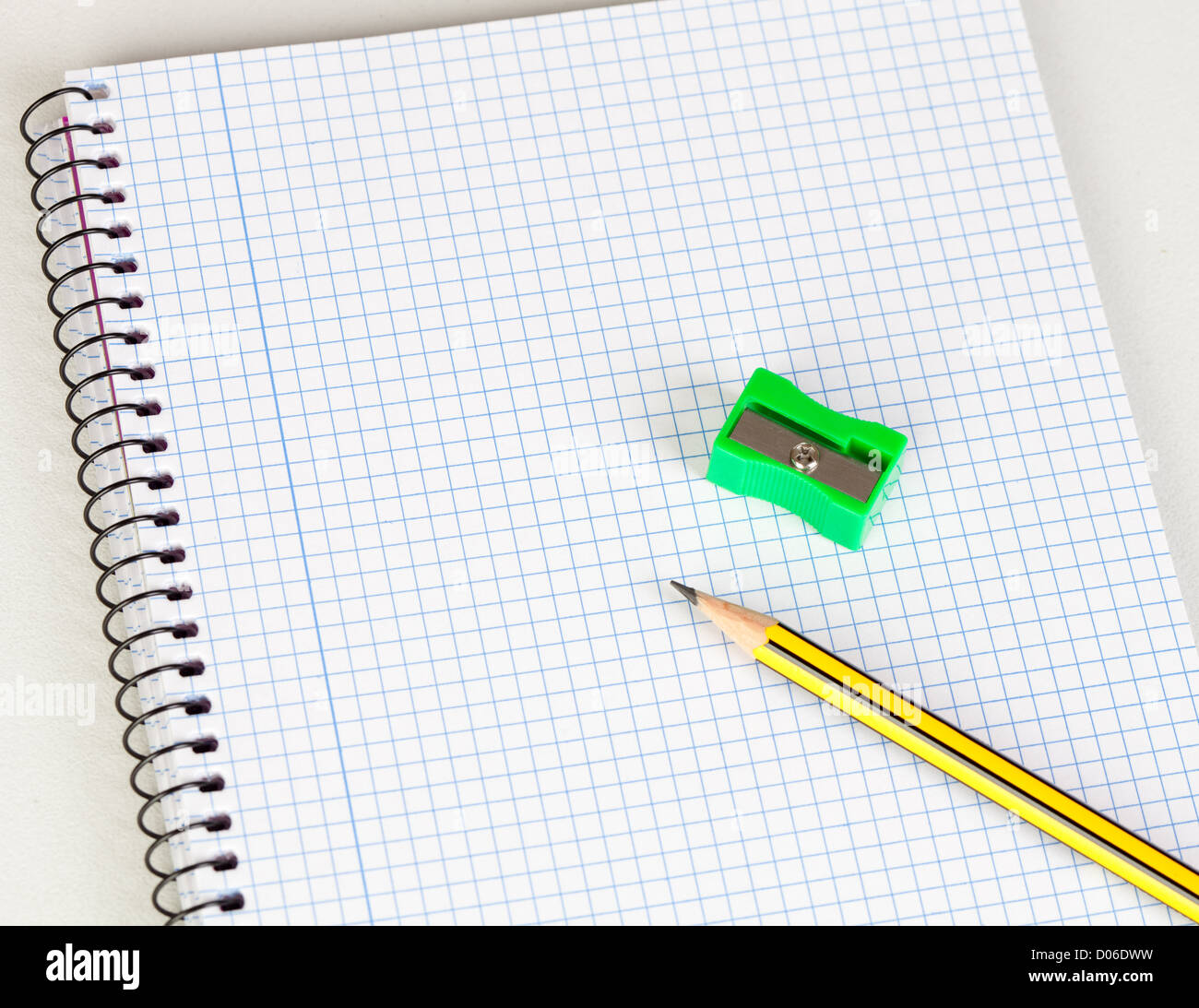 Sharp pencil and sharpener on a spiral notebook in blank Stock Photo ...